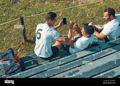 Look At Where We Are On The Leaderboard Shot Of A Rugby Player Showing His Teammates Something