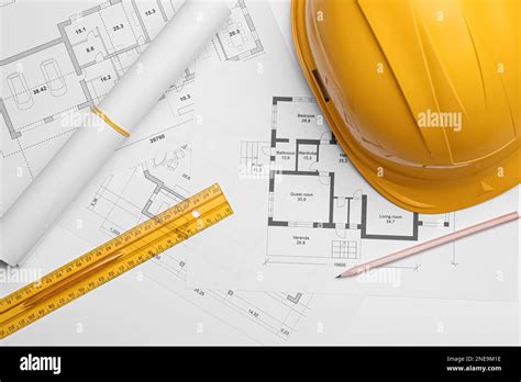 Flat Lay Composition With Blueprints And Hardhat On White Background