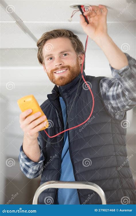 Man Measuring And Cheking Power Supply Voltage With Digital Multimeter