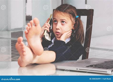 Portrait Of Very Happy Cute Young Business Girl With Bare Feet On The Table Works With Laptop