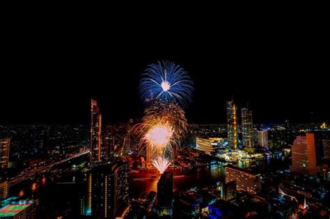 Premium Photo Firework Display Over City Lit Up At Night High Angle View Of Illuminated Buildings