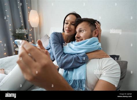 Guy With Slight Indisposition In Bed In Company Of His Girlfriend Stock