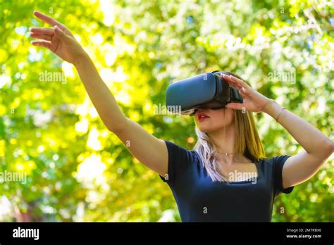 Woman With Virtual Reality Glasses Enjoying Nature Imagining Herself
