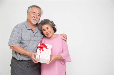Premium Photo Cheerful Asian Senior Man Giving A Thumb Up And Looking At The Camera Isolated