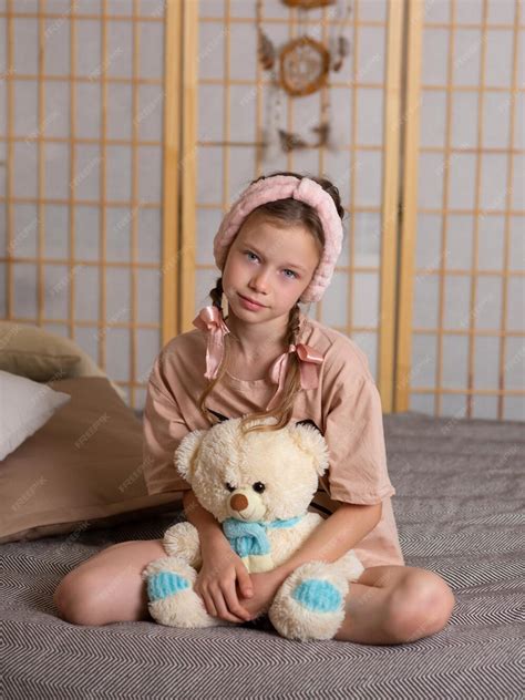 Premium Photo A Girl In Beige Pajamas And A Pink Bandage And With