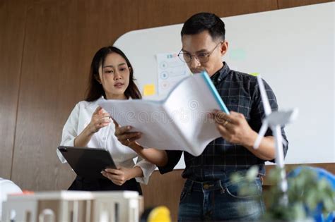 Sustainability And Engineering Engineers Reviewing Project Plans For Sustainable Building