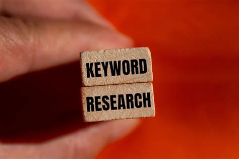 Premium Photo Keyword Research Message Written On Wooden Blocks With Orange Background