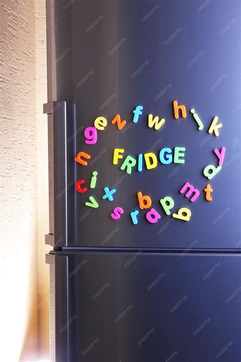 Premium Photo Word Fridge Spelled Out Using Colorful Magnetic Letters