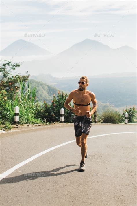 Man Running Topless In Uphill On The Asphalt Road In Hot Summer Weather Panoramic Mountain View