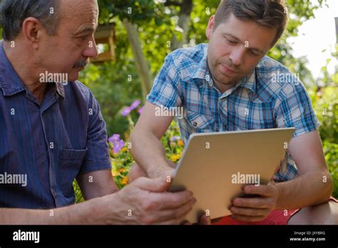Adult Men Smiling And Searching Something In Internet Stock Photo Alamy