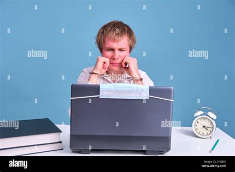 Crying Man With Computer And Handcuffs Studio Blue Background Stock Photo Alamy