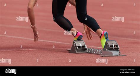 Athlete Female Feet On Starting Block Ready For A Sprint Start Stock