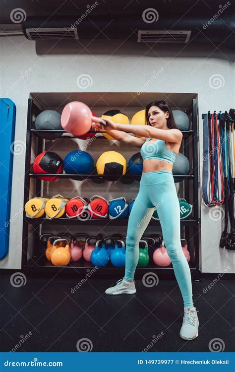 Young Adult Girl Doing Strength Exercises In The Gym Stock Image