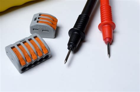 Premium Photo Electrical Terminal Blocks And Multimeter Probes On A