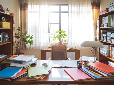 A Cozy Teacher S Office Features A Desk With A Computer Lamp And Plant Books And Documents