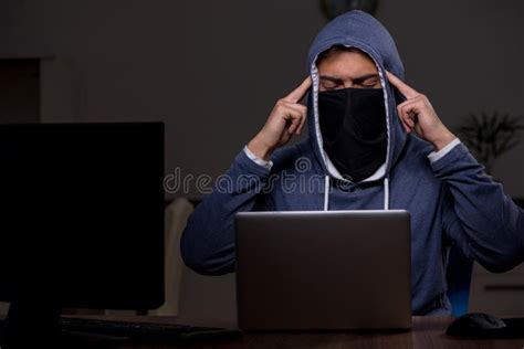 male hacker hacking security firewall late in office stock image