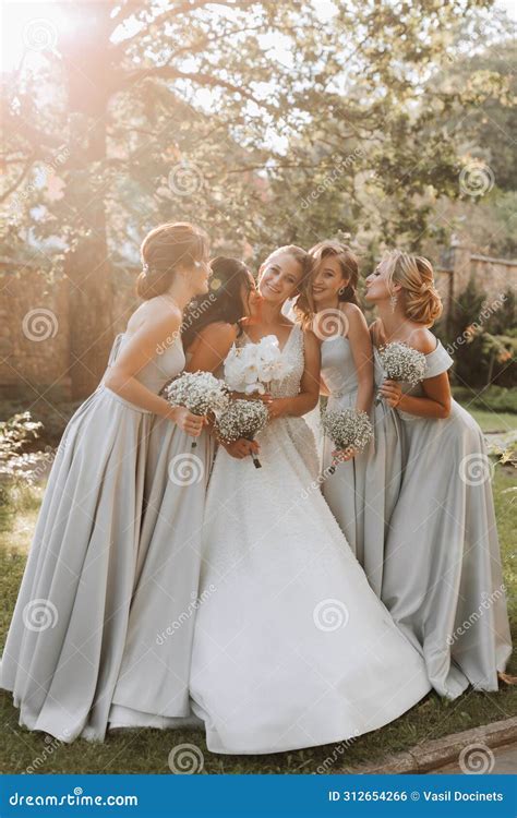 Group Of Beautiful Girls With Bride In Matching Dresses Smiling