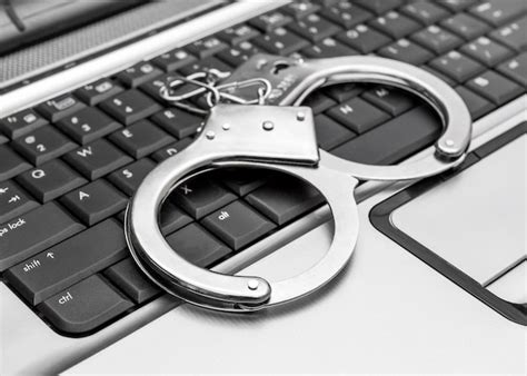 Premium Photo Handcuffs On The Laptop S Keyboard Cyber Crime Concept
