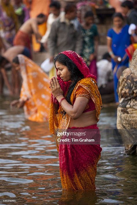 Indian Hindu Pilgrim Bathing And Praying In The Ganges River At News