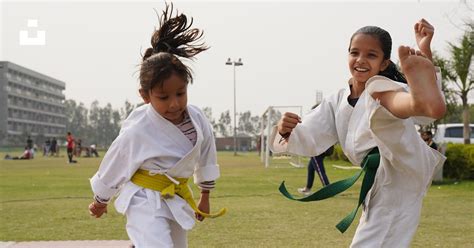 낮 동안 푸른 잔디밭에 서 있는 흰색 긴팔 셔츠를 입은 여성 2명 사진 Unsplash의 무료 카라테 이미지
