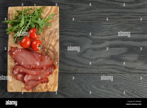 Smoked Ham Prsut With Cherry Tomatoes And Arugula Stock Photo Alamy