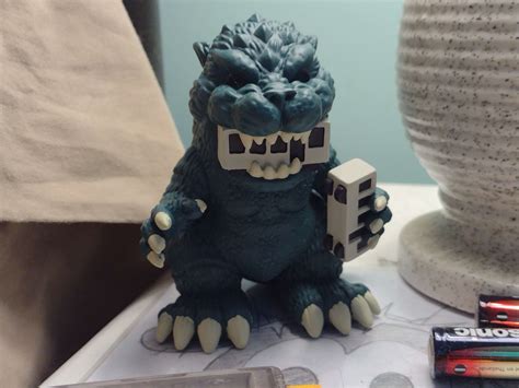 A Tiny Godzilla Eating A Train R Godzilla