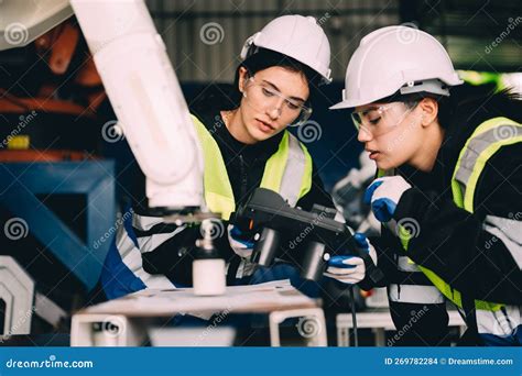 Female Technician Engineer Using Controller Checking Robotic Machine