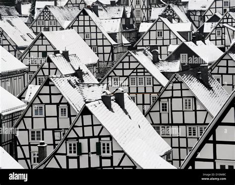 Snow And Ice Cover The Roofs Of Historic Timbered Framed Houses In
