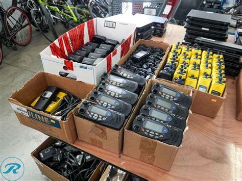 Trays Of TAIT Way Radios Batteries Chargers And Radios Roller