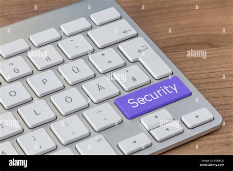 Security Written On A Large Blue Button Of A Modern Keyboard On A Wooden Desktop Stock Photo Alamy