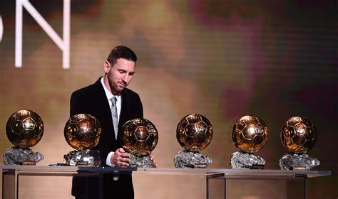 Download Messi Lifts The Ballon Dor Trophy Wallpaper