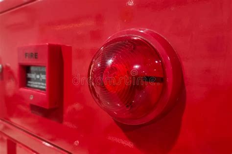 A Close Up Of A Red Fire Alarm System With A Warning Light And