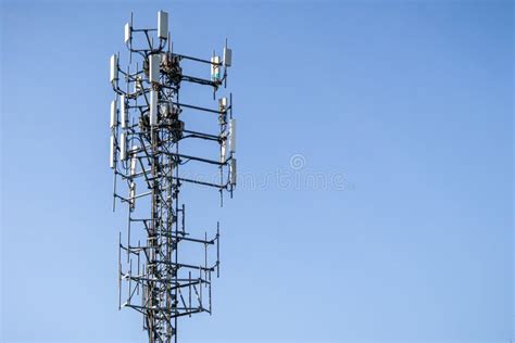 Tall Monopole Cell Tower With Metal Scaffolding And Antennas Grey