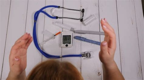 A Diabetic Woman Looks At A Glucose Meter With A Very High Blood Sugar