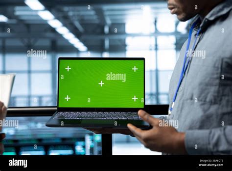 Employees In Data Center Using Isolated Screen Mockup Laptop