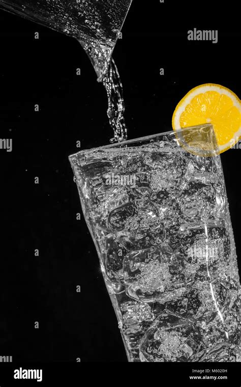 Sparkling Water Overflow Over Ice Cubes Stock Photo Alamy