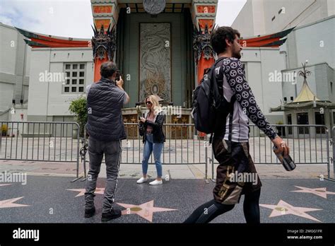 People Walk And Take Photos On The Walk Of Fame Outside Tcl Chinese