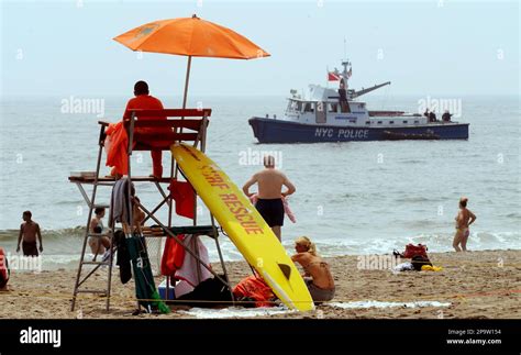 A Lifeguard Looks Out Towards A New York City Police Department Boat