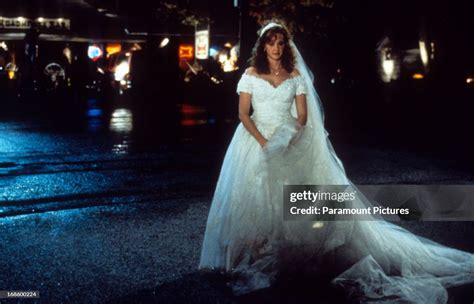 Joan Cusack Standing In The Street In A Wedding Gown In A Scene From