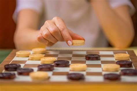 Checkers Player Close Up Photo Of A Girl Playing Checkers Indoor At