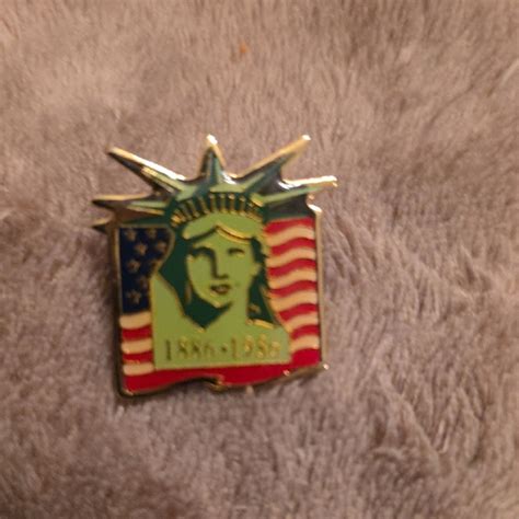 Accessories This Commemorative Pin Featuring The Statue Of Liberty