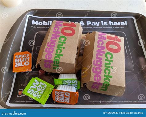 Two Ten Piece Chicken Mcnuggets On A Tray With Dipping Sauces Spicy