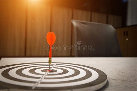 Rred Dart Arrow Hitting In The Target Center Of Dartboard On Bullseye