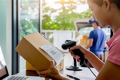 Premium Photo Side View Of Woman Scanning Cardboard Box