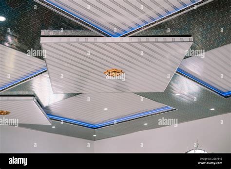 A Contemporary Ceiling Featuring Geometric Panels Integrated Lighting And A Sleek Modern