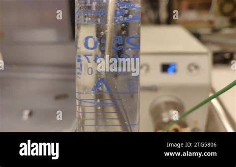 Nitrogen Bubble Through Organic Solvent In Measuring Cylinder In A