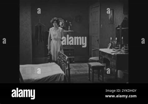 Us In This Silent Drama A Woman Smashes A Tenor Guitar On A Bed Frame Her Husband
