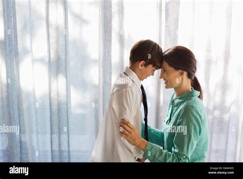 Mother And Son Touching Foreheads At Window Stock Photo Alamy