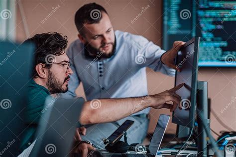 Programmers Engrossed In Deep Collaboration Diligently Working Together To Solve Complex