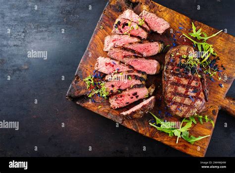 Barbecue Dry Aged Angus Roast Beef Steak With Rocket Lettuce And Herbs